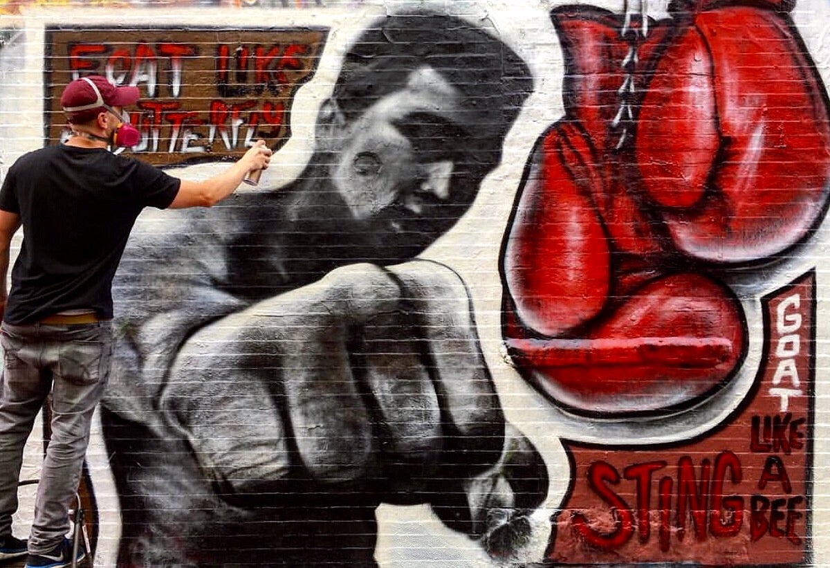 Artist Paints Muhammad Ali Mural in Cambridge's Central Square